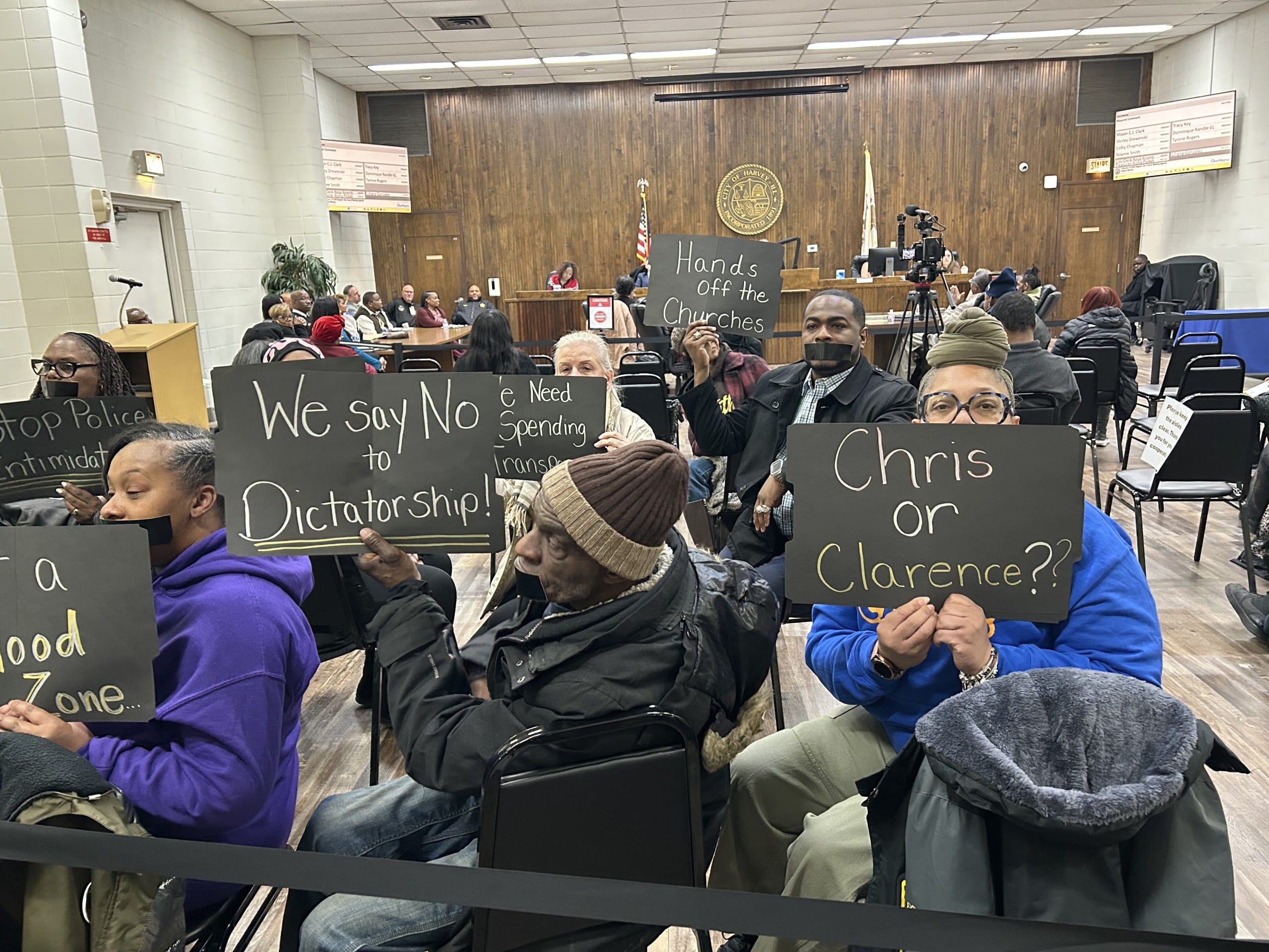 Residents tape mouths shut in another silent protest at City Hall ...